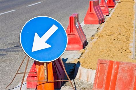 Premium Photo Arrow Sign On Barricade By Road
