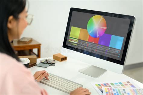 Female Designer Analyzing Color Schemes On Computer Screen For An Interior Project Stock Image