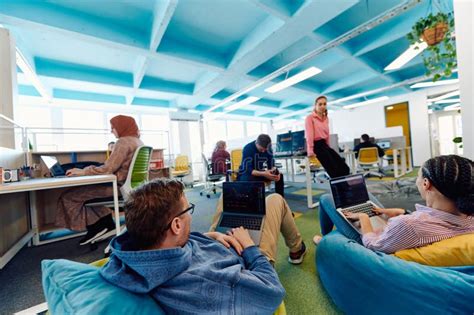 A Team Of Successful Programmers Sits In A Startup Office Strategizing New Business Projects