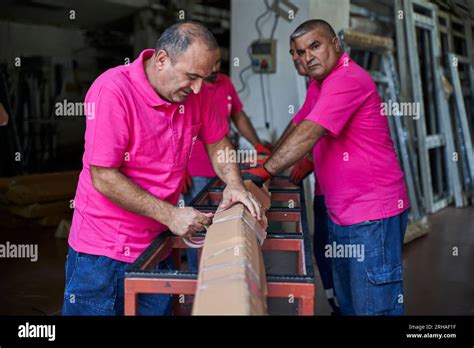 Workers Packing Cardboard Box In Warehouse For Shipment An Operator