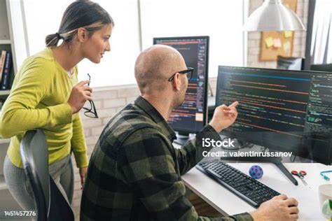 Software Programmers Analyzing Html Code And Database Brainstorming Script Ideas To Develop New