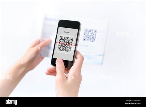 Woman Scanning QR Code In The Magazine On Mobile Smart Phone Stock Photo Alamy