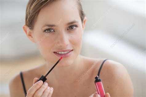 Woman Applying Gloss Stock Image C Science Photo Library