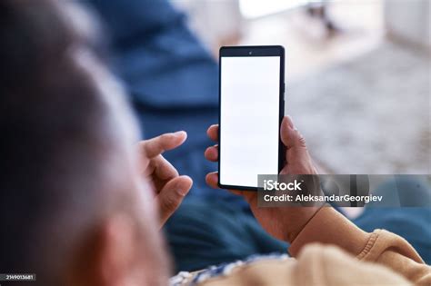 Male Scrolling Through Different Social Media Images On Smartphone