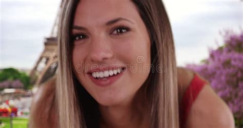 Close Up Of Cute Millennial Girl Blowing Kisses To Camera By Eiffel