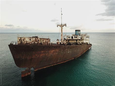 Abandoned Rusty Ship On Ocean By Stocksy Contributor Guille Faingold