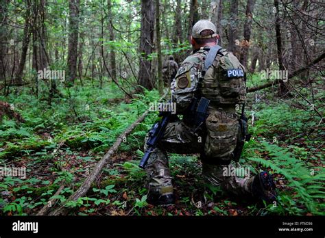 A Bortac Team Member Coordinates With His Team During The Manhunt For