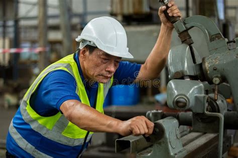 Elderly Male Worker Wear Hardhat Working At Machine In Factory Man Technician Control Metalwork