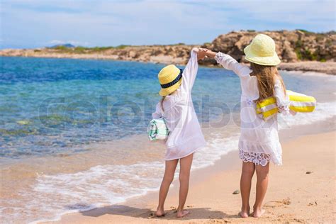 Adorable Cute Girls Have Fun On White Beach During Vacation Stock