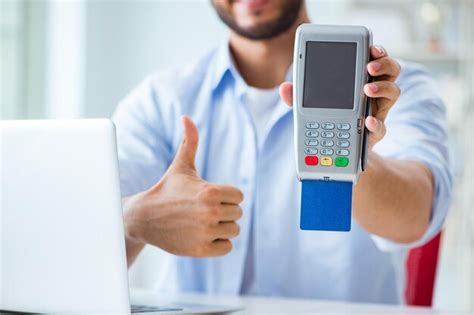 Premium Photo Man Processing Credit Card Transaction With Pose Terminal