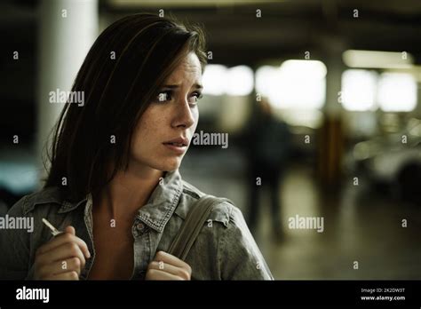 Something Doesnt Feel Right A Young Woman In A Parking Lot Looking Concerned As Someone