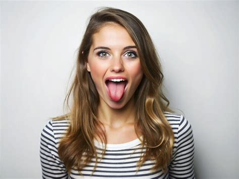 Premium Photo A Young Women Sticking Her Tongue Out Playfully