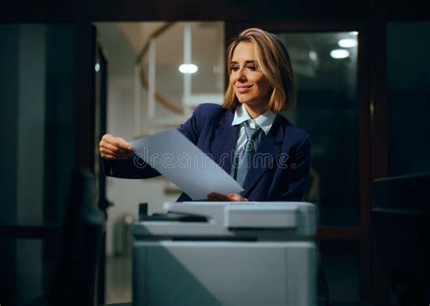 Office Worker Using The Printer To Print Documents At Work Stock Image