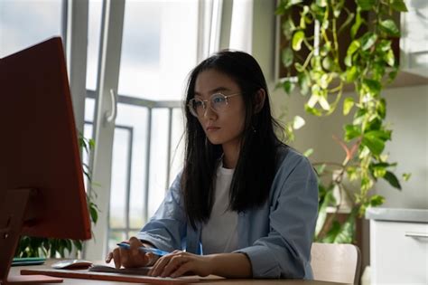 Premium Photo Focused Asian Woman It Developer Wearing Glasses Writing Code On Computer While