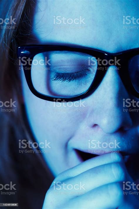 Sleepy Young Woman In Nerd Glasses Yawns Covering Her Open Mouth With