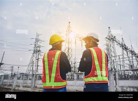 Man And Women Engineering Standing Communication At Power Plant Electrical System Background