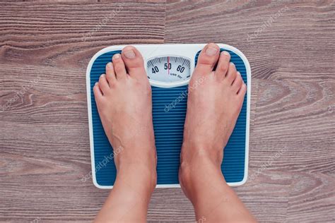 Girl Is Measuring Her Weight On The Scales Stock Photo Airkost 83538802