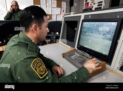South Texas Border Patrol Agent Monitor Border Activity By Use Of A Remote Surveillance Video