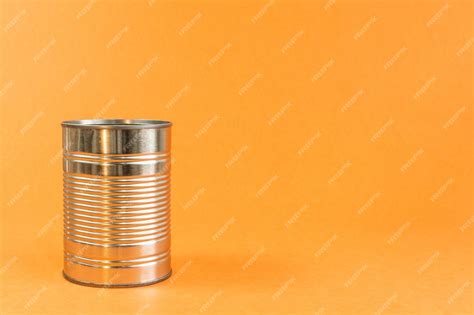 Premium Photo Empty Tin Isolated On An Orange Background Recycling Concept And Environment