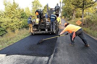 Mitchell Perry With The Benton County Road Department Smooths Asphalt