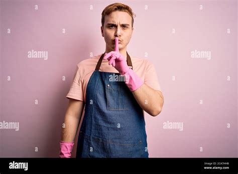 Young Handsome Redhead Cleaner Man Doing Housework Wearing Apron And