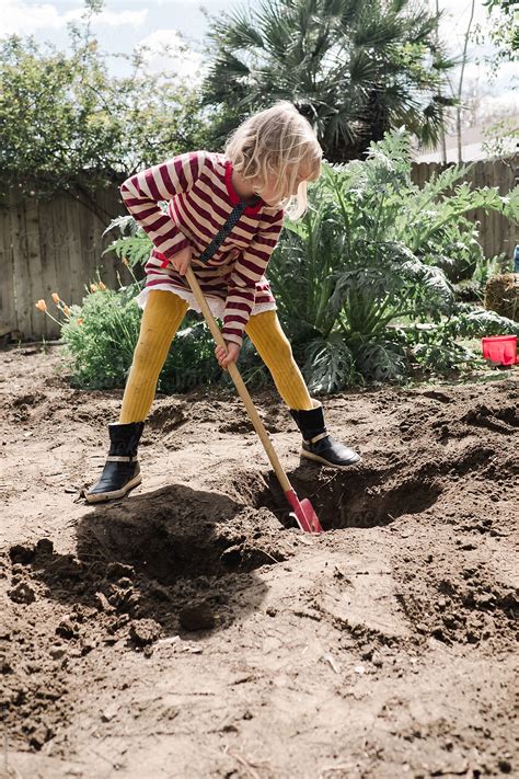 Blonde Girl Digging A Hole By Stocksy Contributor Lea Jones Stocksy