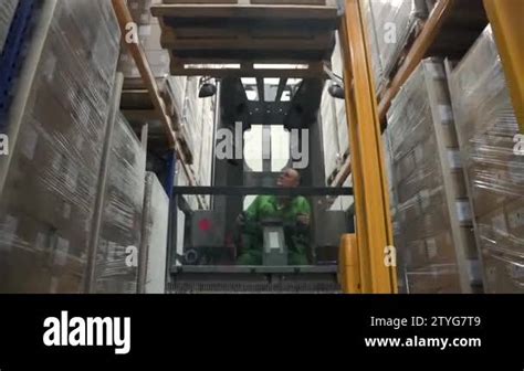 Warehouse Man Worker With Forklift Loader Loading Goods At Shelves Concept Logistics Elevator