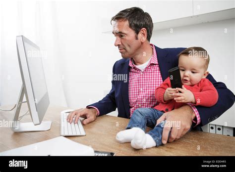 Businessman With Baby Babe Working From Home Stock Photo Alamy