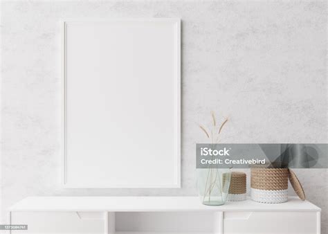 현대 거실의 흰색 벽에 빈 수직 사진 프레임 미니멀한 스칸디나비아 스타일로 인테리어를 모의하세요 그림을 위한 여유 공간 콘솔