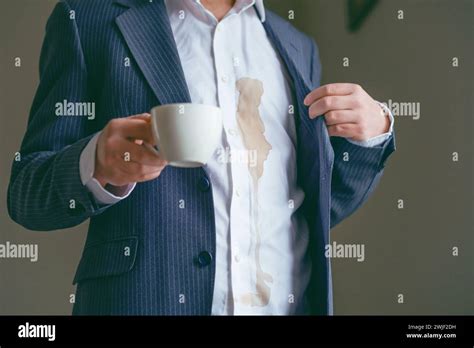 An Unrecognizable Man Spilled Coffee Or Tea On A White Shirt Daily