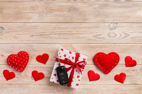 발렌타인 데이 또는 붉은 마음으로 종이에 다른 휴일 수 제 선물 휴가 래퍼에 자동차 키와 선물 상자 디자인에 대 한 오렌지 나무 테이블 복사 공간 평면도 빈 공간에 상자