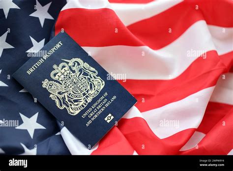 Blue British Passport On United States National Flag Background Close