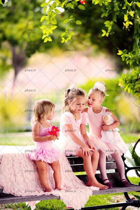 عکس با کیفیت سه دختر در حال بازی روی نیمکت در پارک عکس با کیفیت و تصاویر استوک حرفه ای