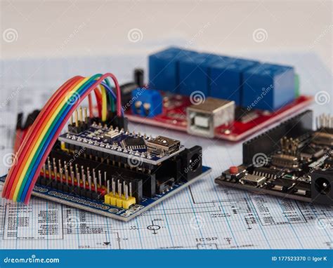 Arduino And Programmers With Peripherals And Expansion Boards Lie On A Gray Background Do It