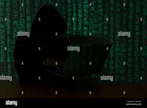 a man in black is hacking personal computer data representing the