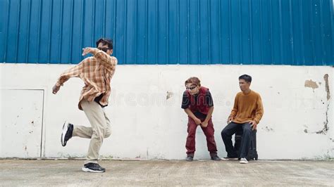 Young Street Dancer Dancing In Hip Hop Style With Friend Cheer Behind