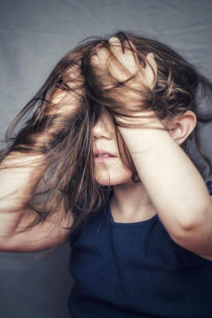 Premium Photo Close Up Of Girl Holding Her Messy Brown Hair