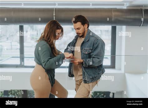 Confident Colleagues In A Positive Office Atmosphere Collaborating Discussing Ideas Sharing