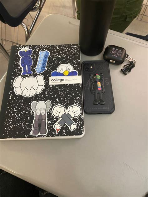 An Open Notebook Sitting On Top Of A Table Next To A Cell Phone And Pen