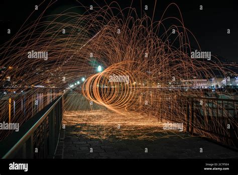 Horizontal Shot Of Steel Wool Effect On A Bridge With Metal Railings At