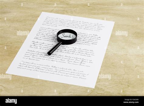 Magnifying Glass Enlarging The Word Search On A Page With Printed Text Laying On A Desk Stock