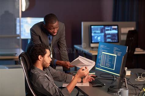 Two Male It Engineers Discussing Documentation At Workplace Stock Image Image Of Online