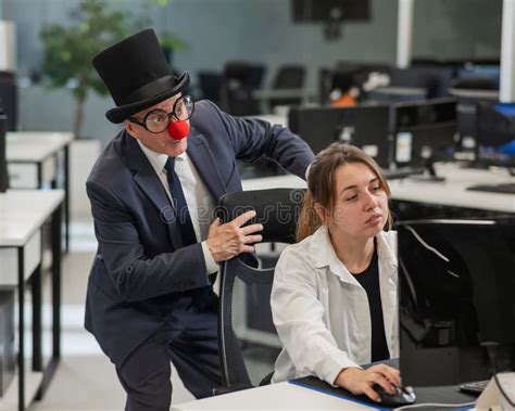 Caucasian Woman Works At The Computer Elderly Man In Clown Costume In