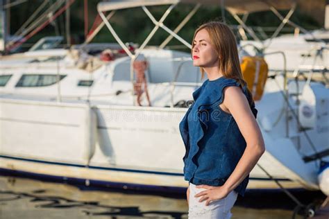 Pritty Woman Posing On The Marina At A Sunny Summer Day At The River