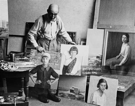 British Artist Harold Harvey Poses With A Selection Of His Portraits