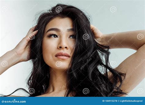 Angle View Of Attractive Brunette Thai Woman Touching Hair On Grey Stock Photo Image Of Woman