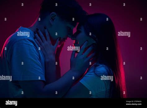 Romantic Loving Caring Young Woman And Man Couple Kissing Against