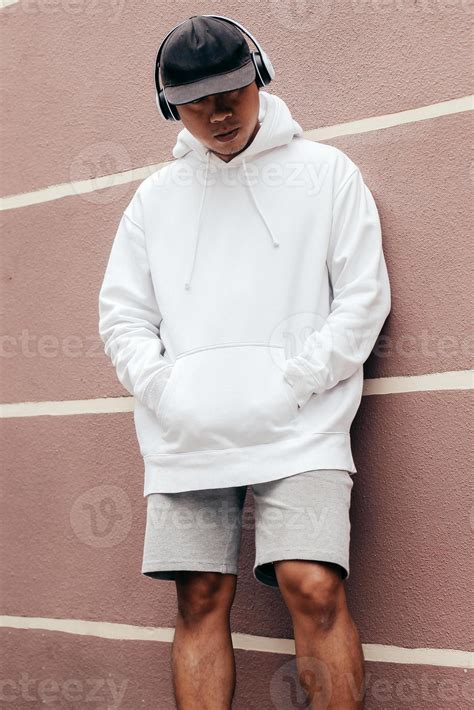 Hipster Man Puts Both Hands In Hoodie Pocket Outdoor Photo Concept For