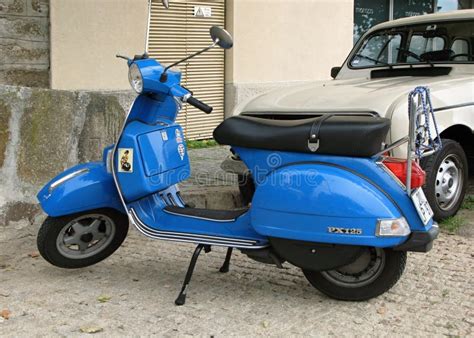Blue Vespa Px 125 Parked Near A White Renault 4 Editorial Stock Image Image Of Shiny Daytime