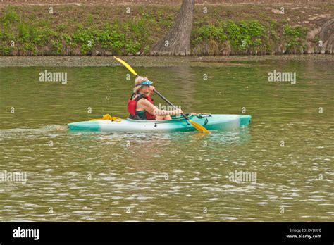 Woman Wearing Personal Floatation Device Pfd Paddling Kayak In River